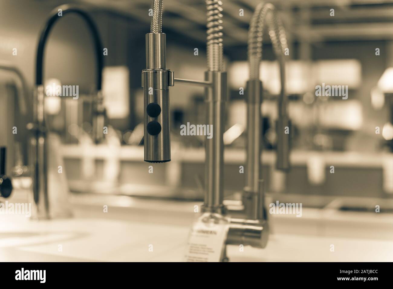 Shiny kitchen faucets with pull-out sprout at furniture showroom in ...