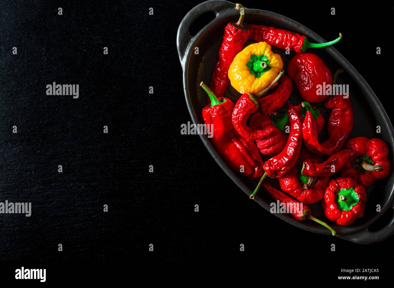 Colorful textured chilli lies in black baking form Stock Photo - Alamy