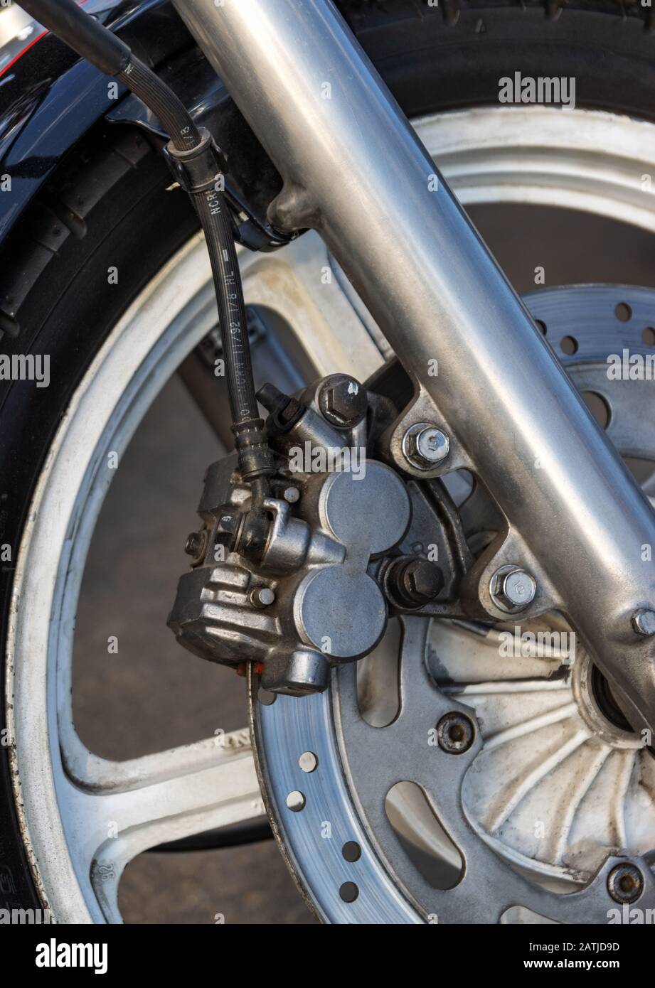 Heavy motorcycle wheel with disc brakes closeup Stock Photo - Alamy