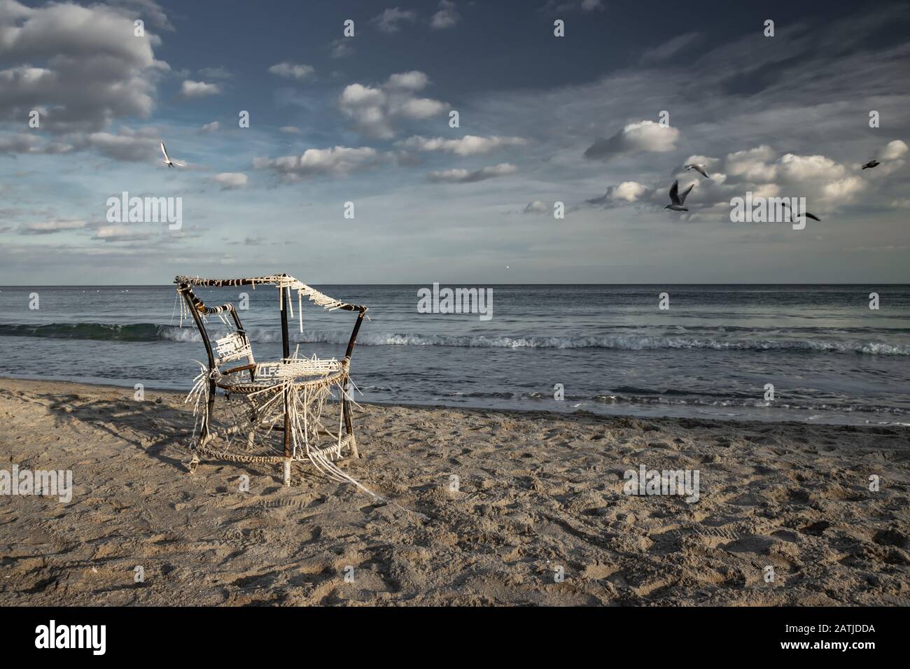 After storm broken plastic rattan chair on the beach. Winter, non ...