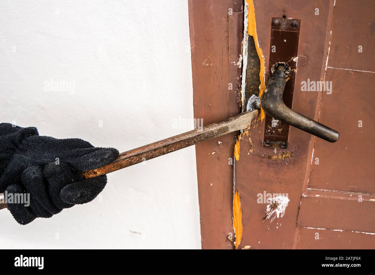 Burglar breaks open a door Stock Photo - Alamy