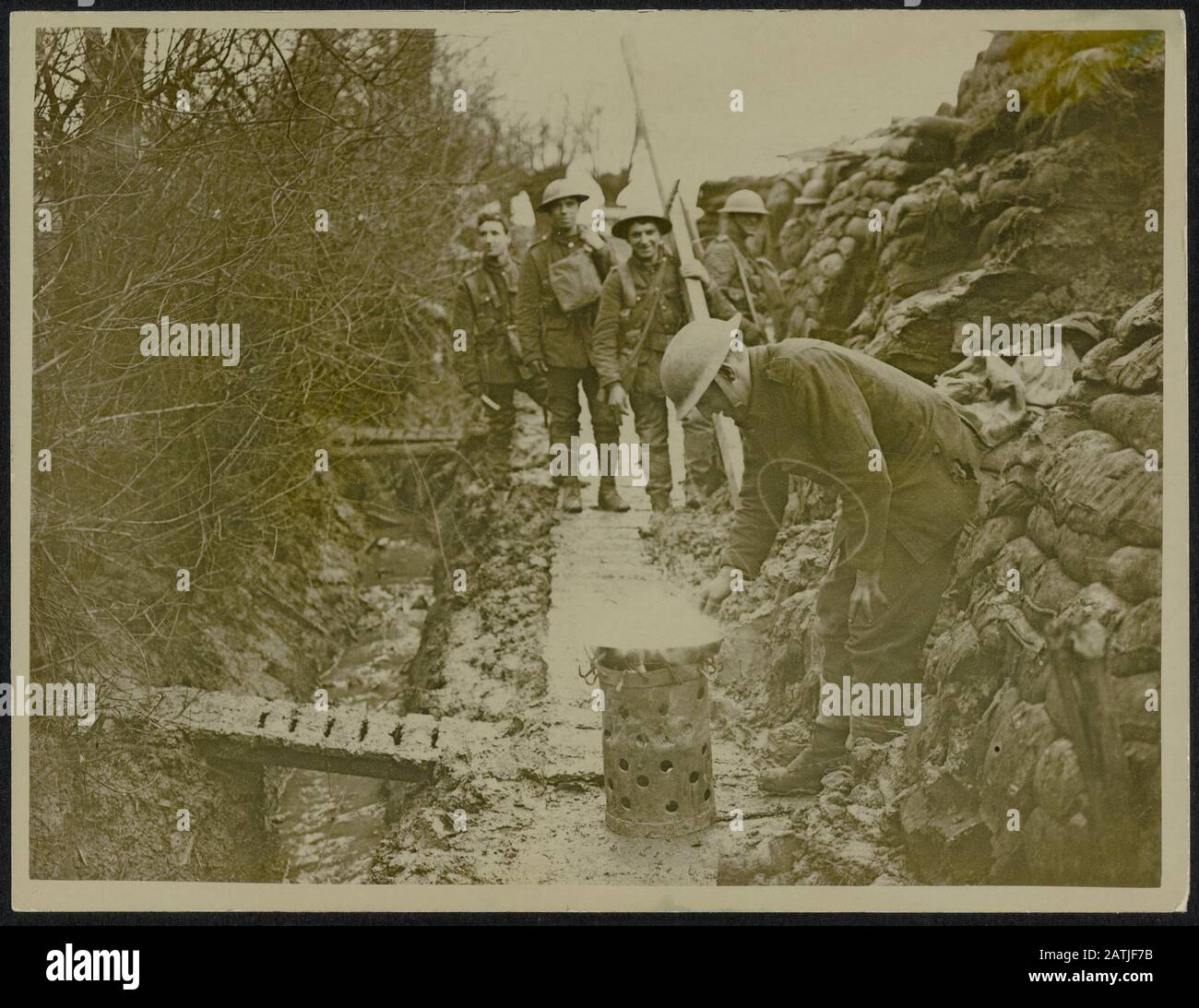 The western front. How Tommy is fed description: Frying his bacon in a ...