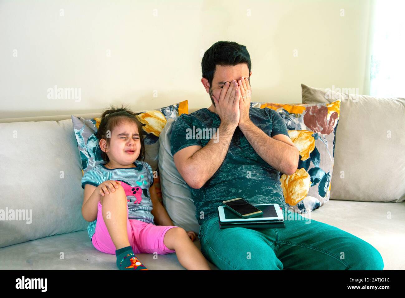 little girl crying to get phone Stock Photo - Alamy