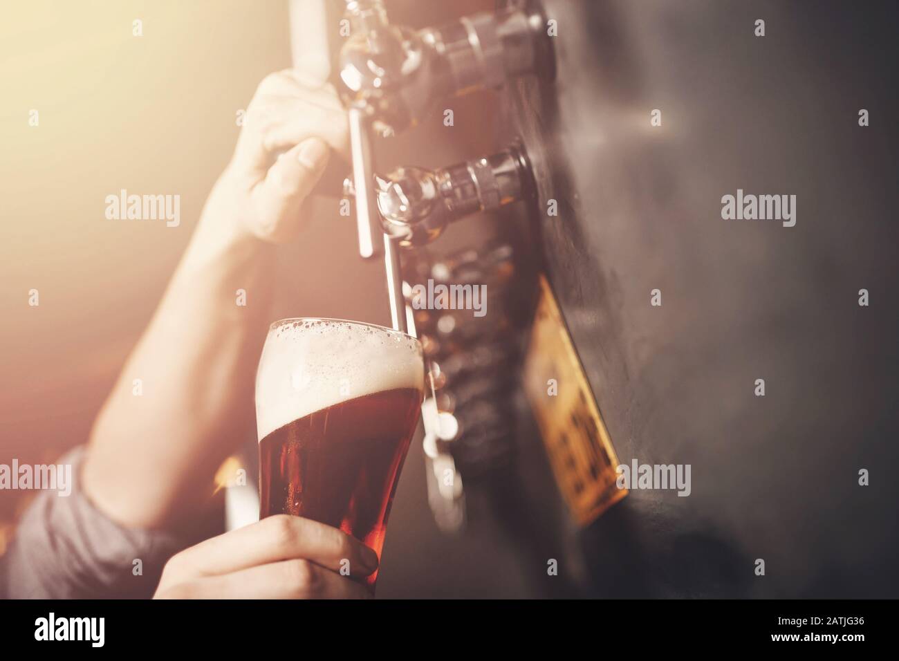 Light Draft cold beer pour in glass from crane in pub Stock Photo - Alamy