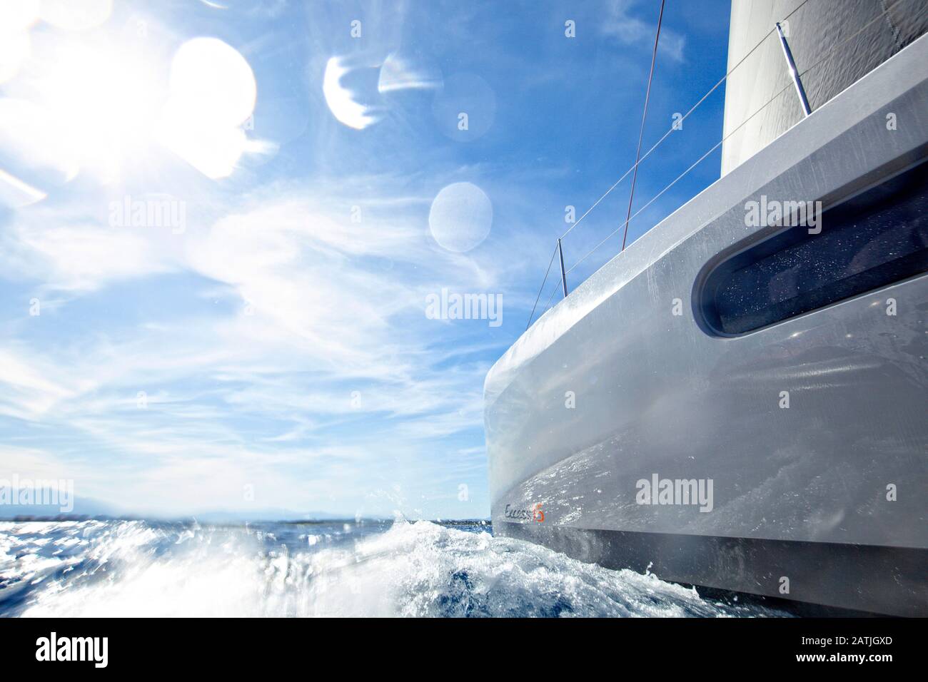 Hull of a cruising catamaran under sails by a beautiful sunny day Stock ...