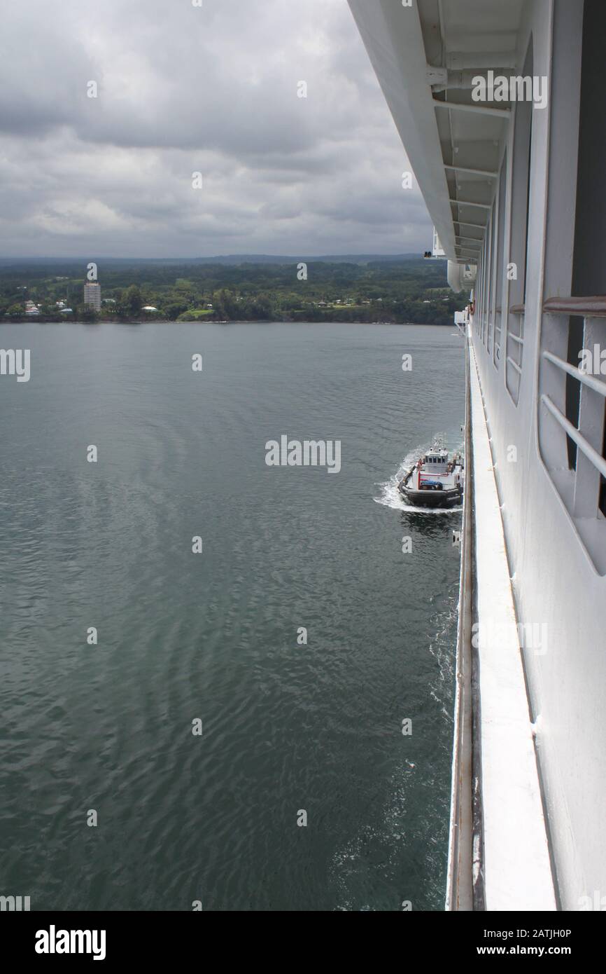 Tugboat assisting with docking of cruise ship in Hilo harbor, Hawaii ...