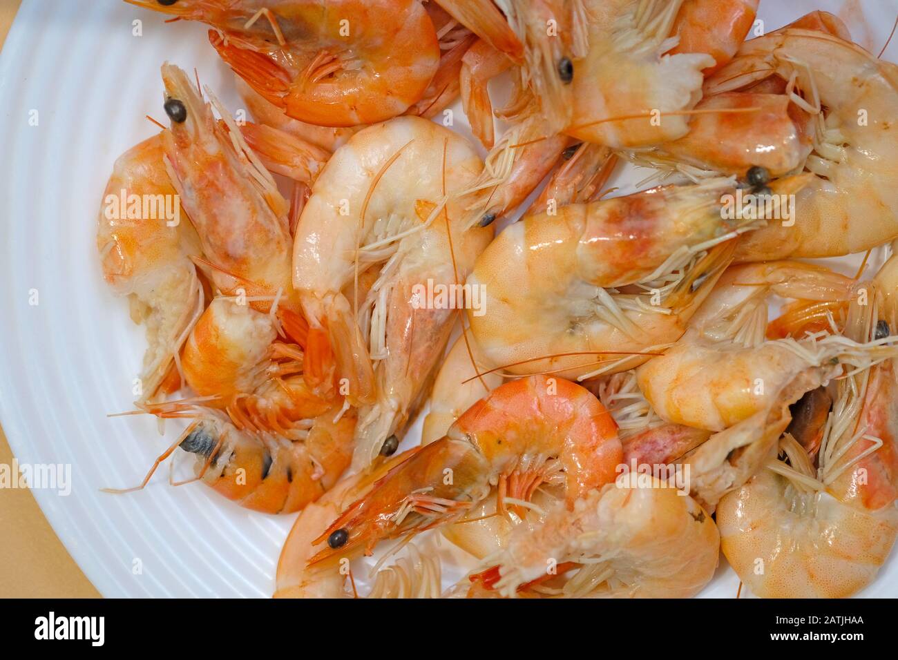 Large boiled shrimp top view. Shrimp on a white plate, an appetizer for ...