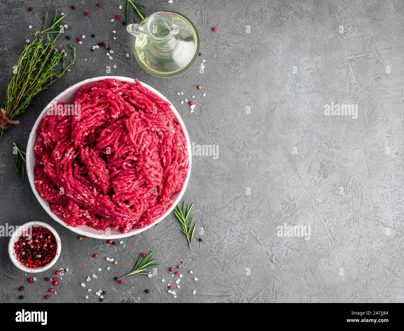 Mince beef, ground meat with ingredients for cooking on dark gray ...