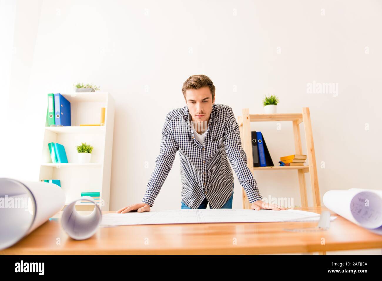 Smart young engineer looking on plan for his project Stock Photo - Alamy