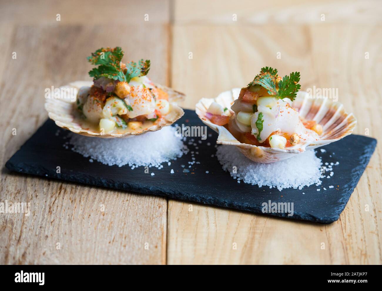 Fresh Scallops Ceviche served in a shell are shown on a table at a ...