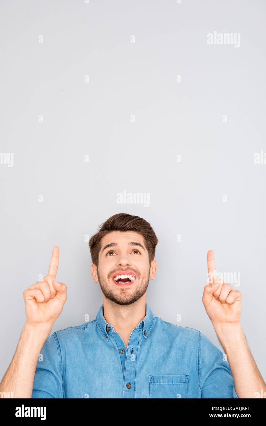 Portrait of cheerful smiling man pointing up with fingers Stock Photo ...