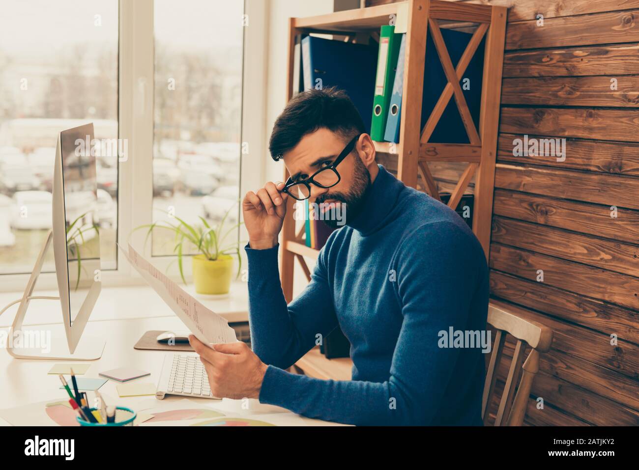 Serious young man doing paperwork hi-res stock photography and images ...