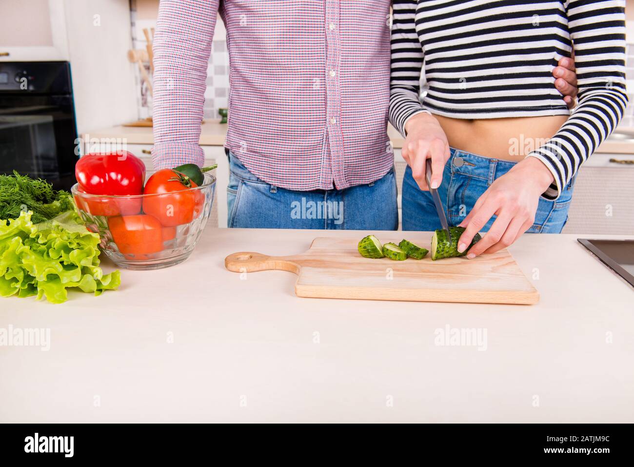 Close up photo of couple in love cutting cuumbers Stock Photo - Alamy