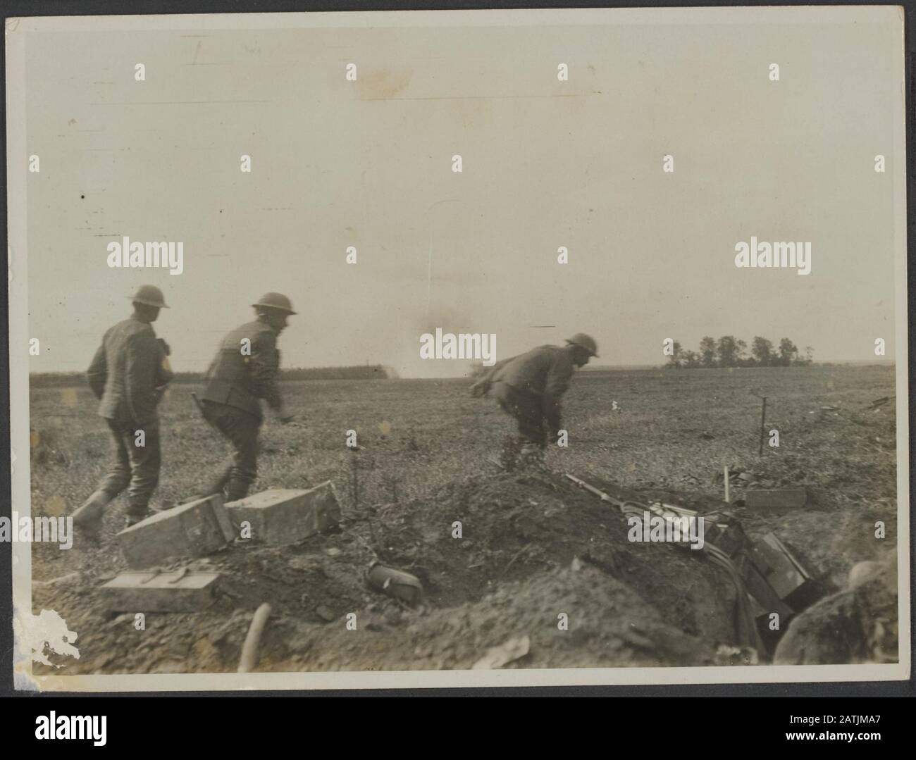 Description: Soldiers pull up in a trench while away bombs strike date ...
