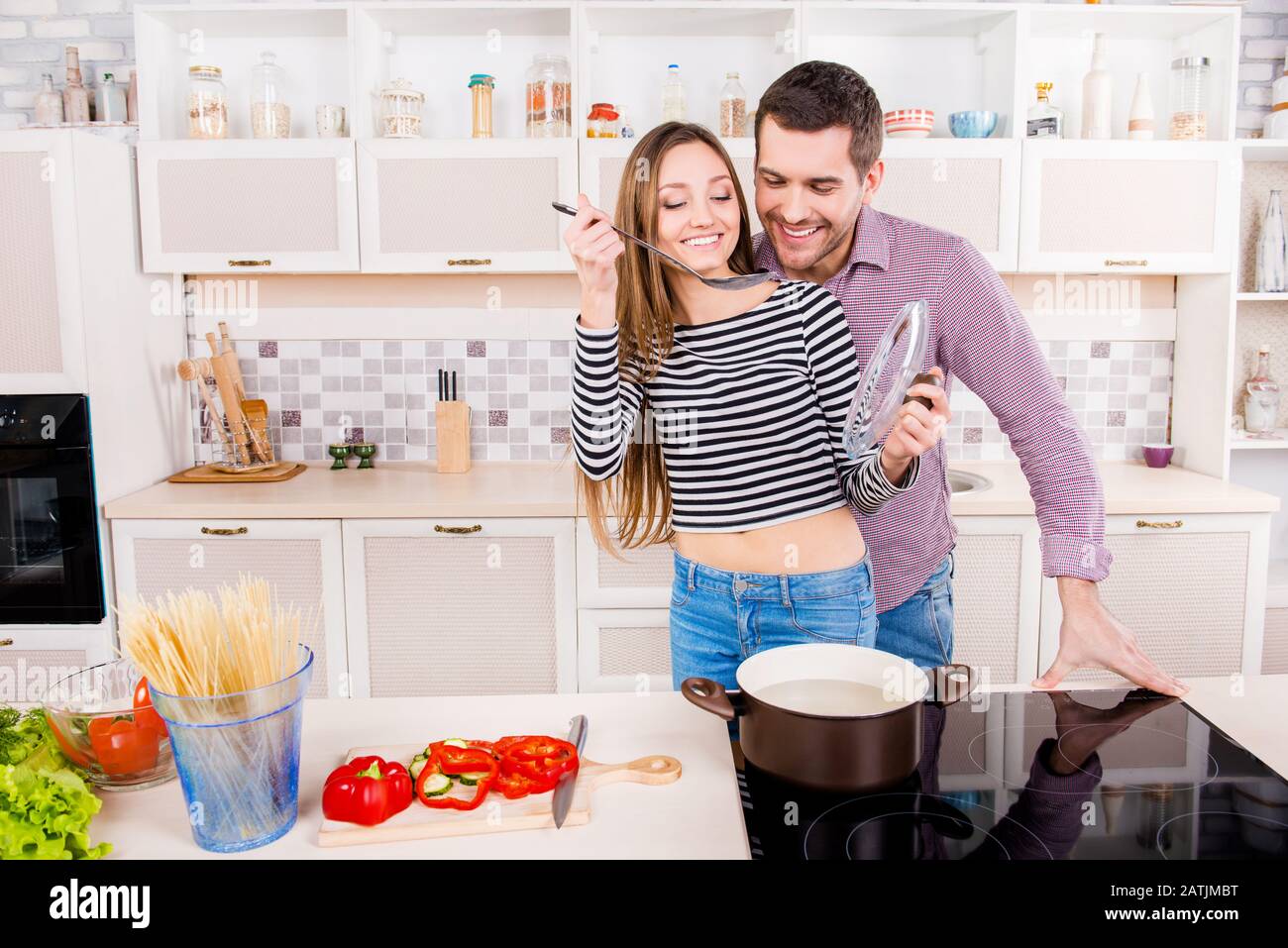 Portrait of cute couple in love chilling hot meal in the kitchen Stock ...