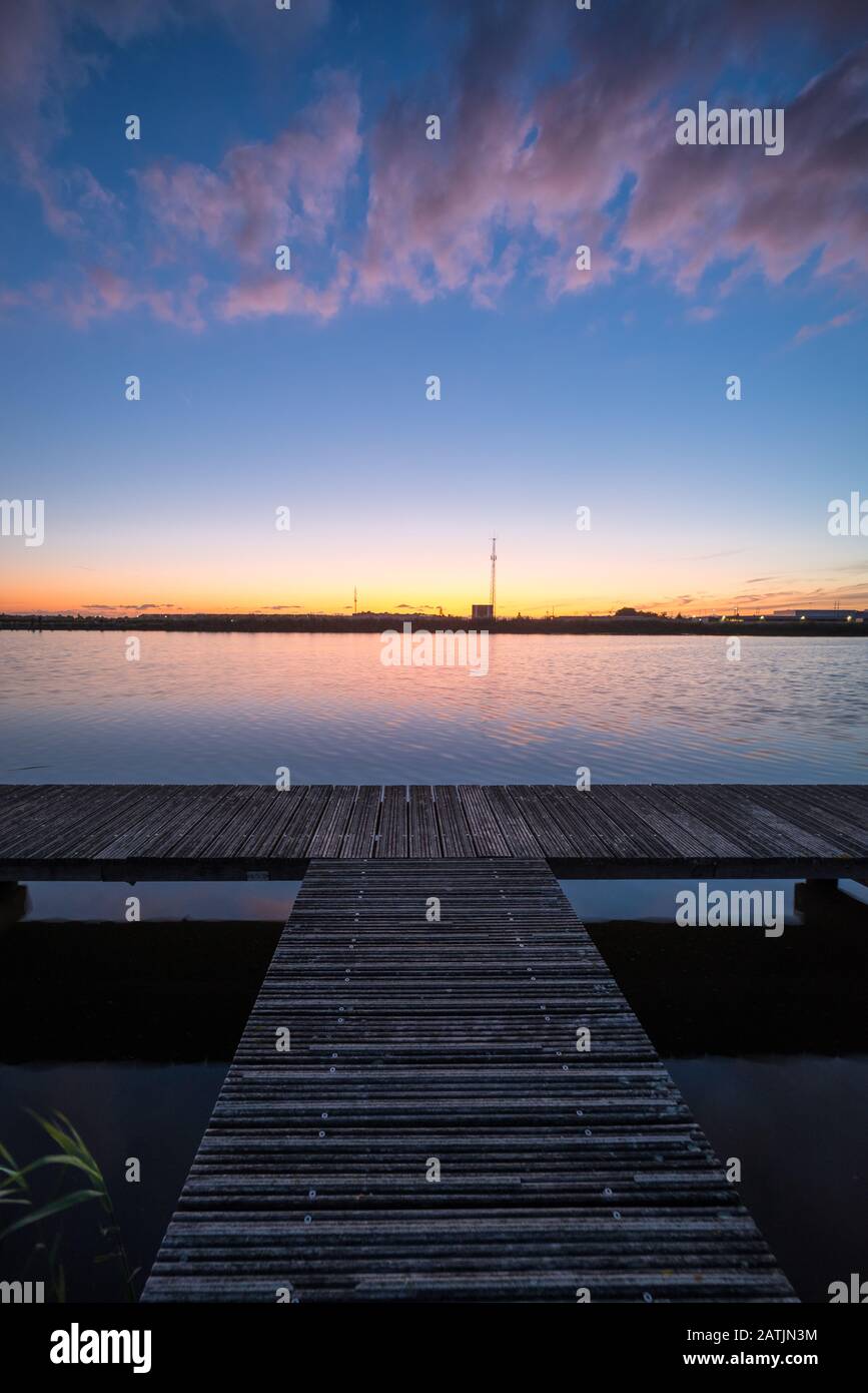 Calm beach pier distance sunset hi-res stock photography and images - Alamy