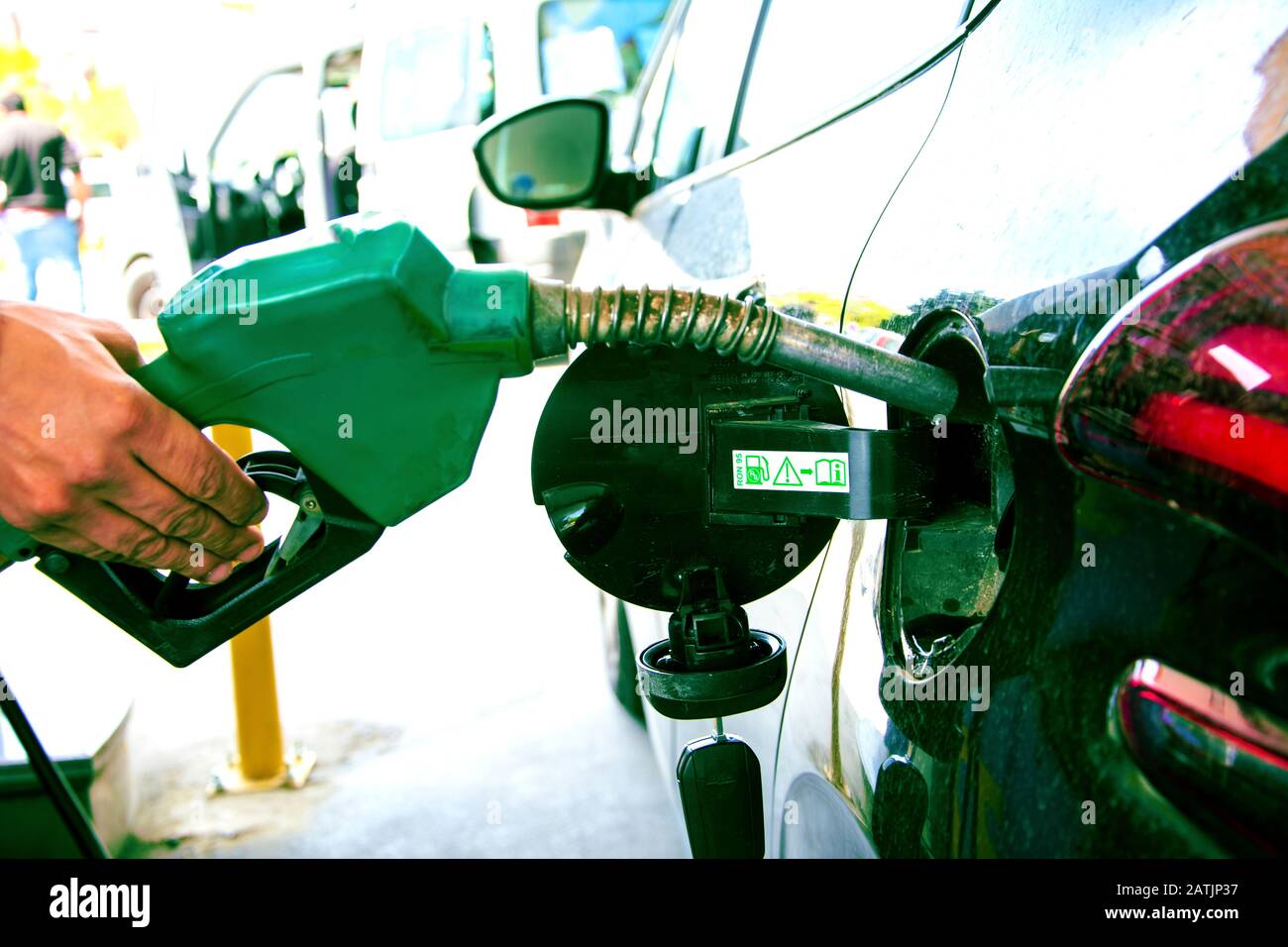 Hand holding gasoline pomp Stock Photo - Alamy