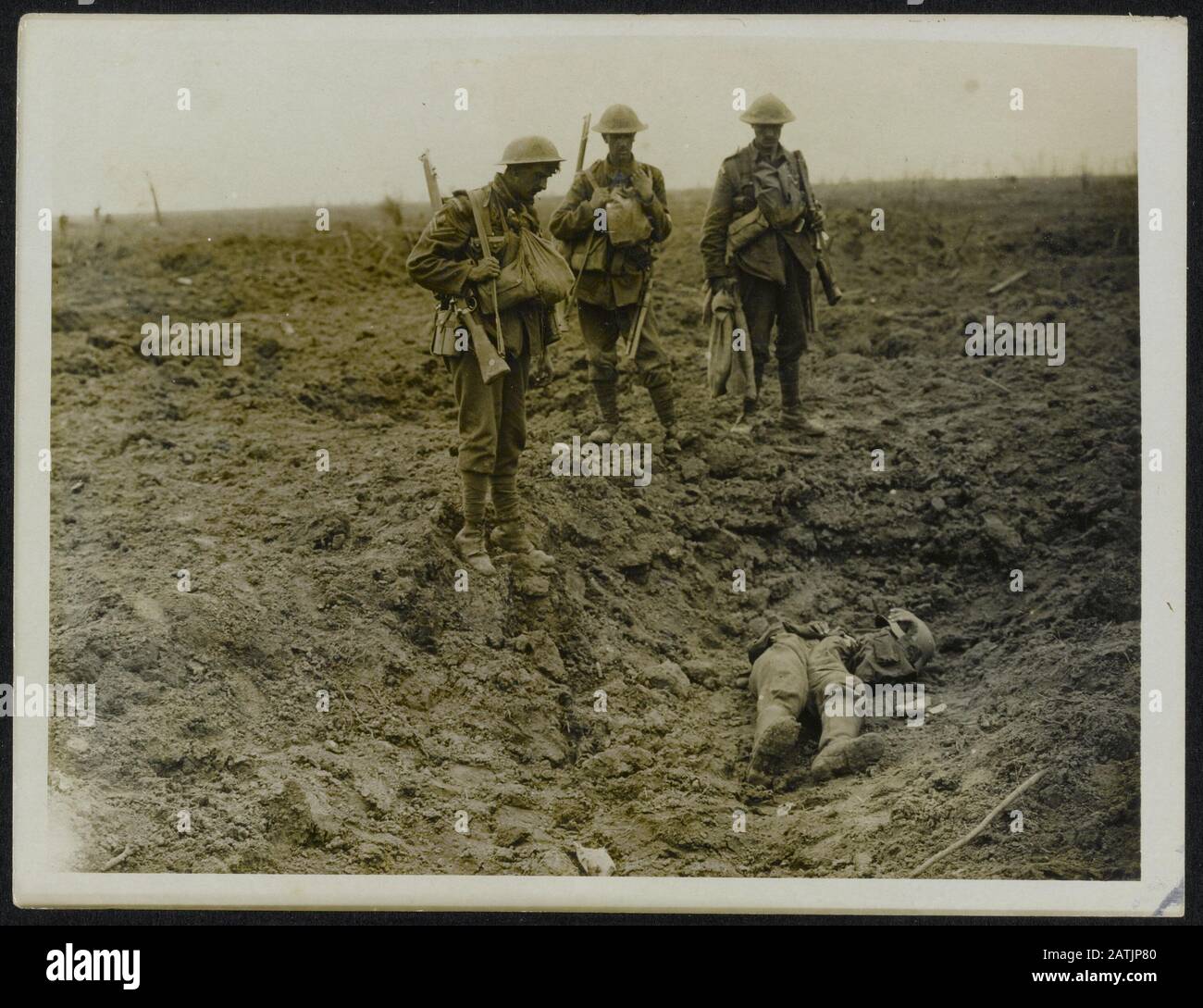 The battle of Flanders Description: Tommies looking at a dead Boche ...