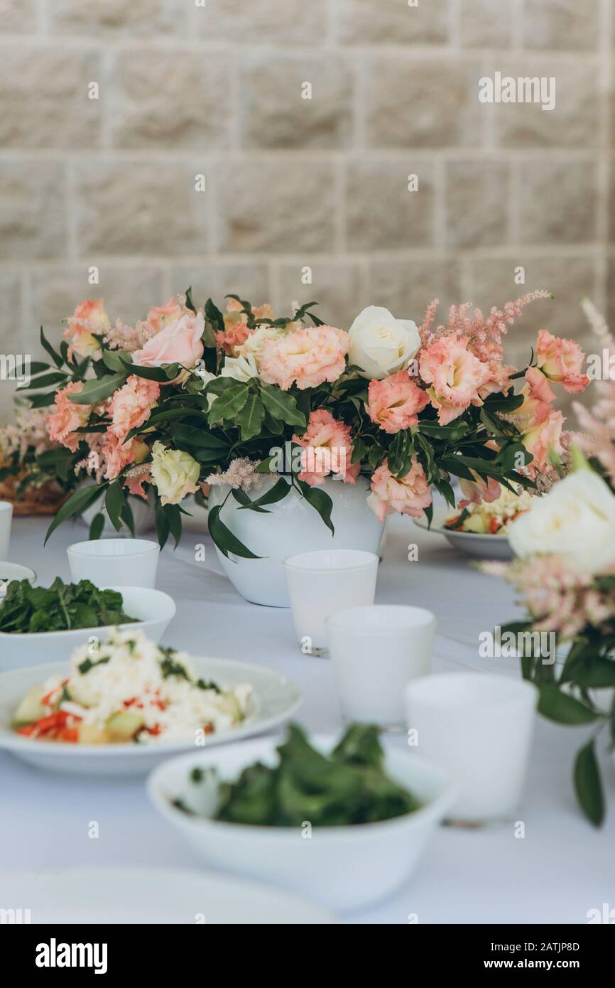 Decoration of flowers on the table with various food or snacks ...