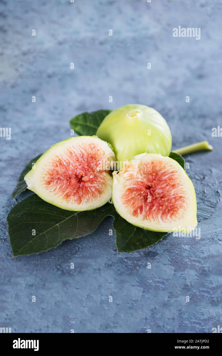 Ripe sweet green figs with green leaves. Healthy mediterranean fig ...