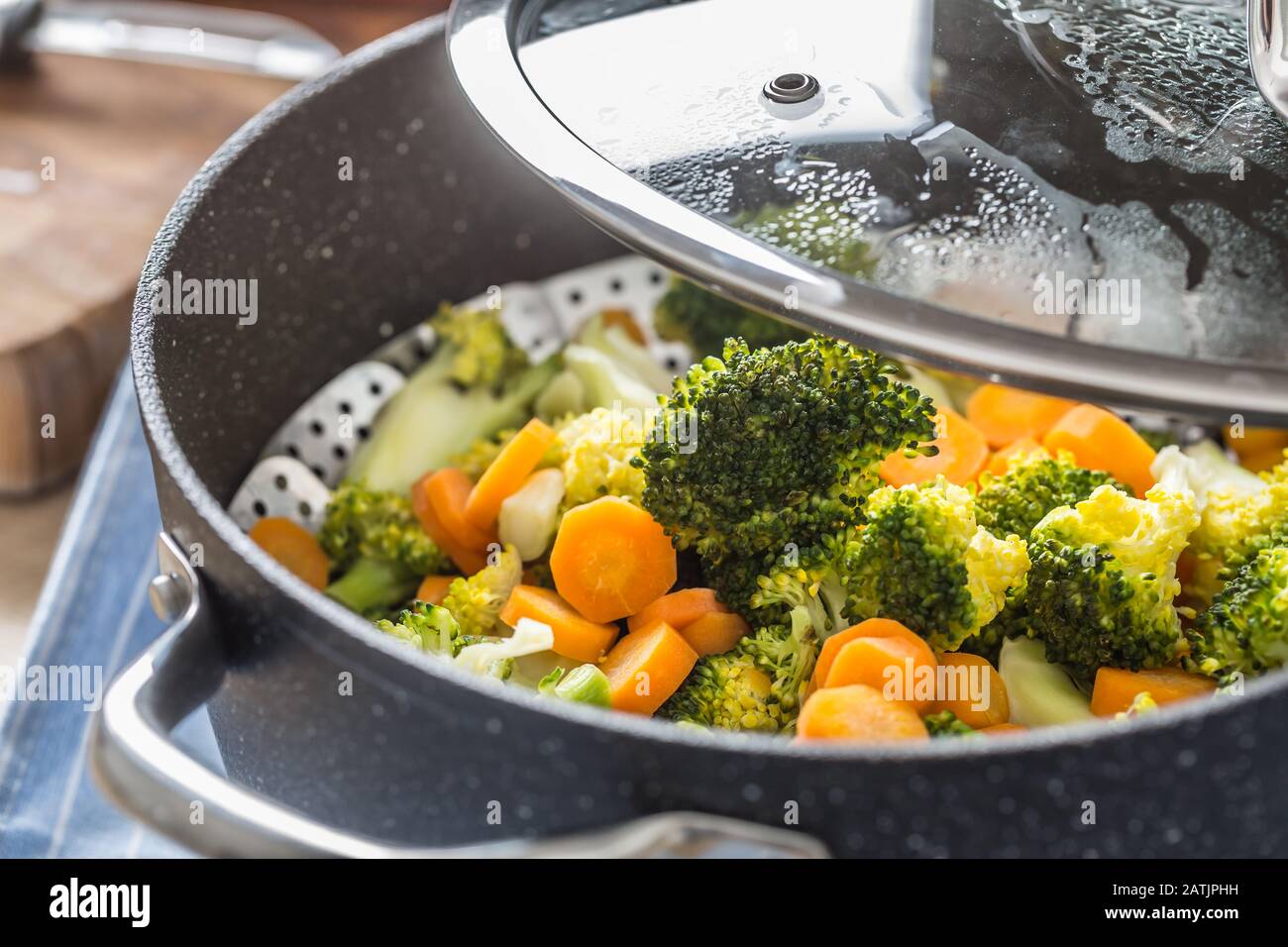Steamed mixed vegetable in black pot. Healthy vegetable concept Stock ...