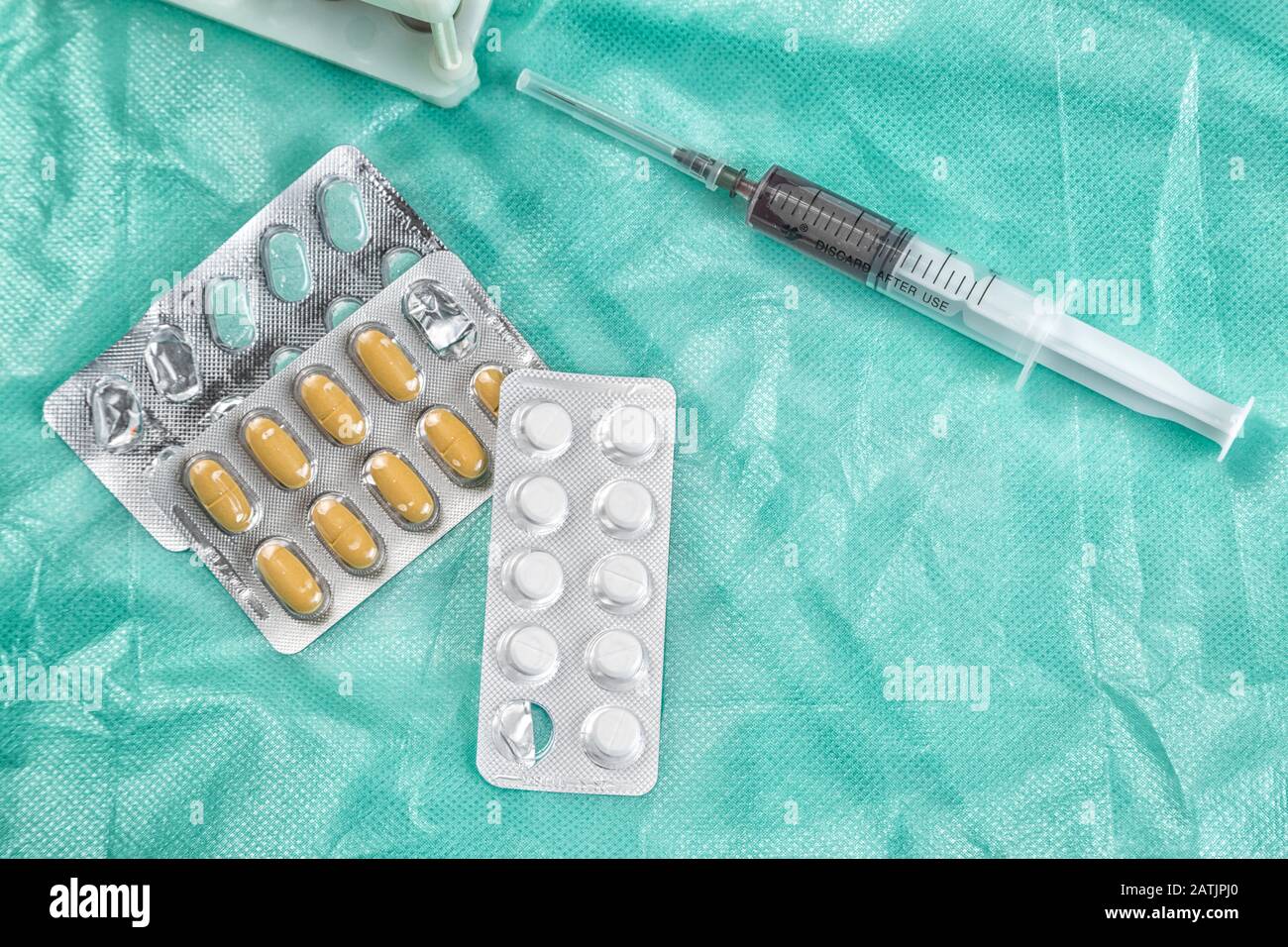 medications in packages and blood samples in a syringe . on a medical ...