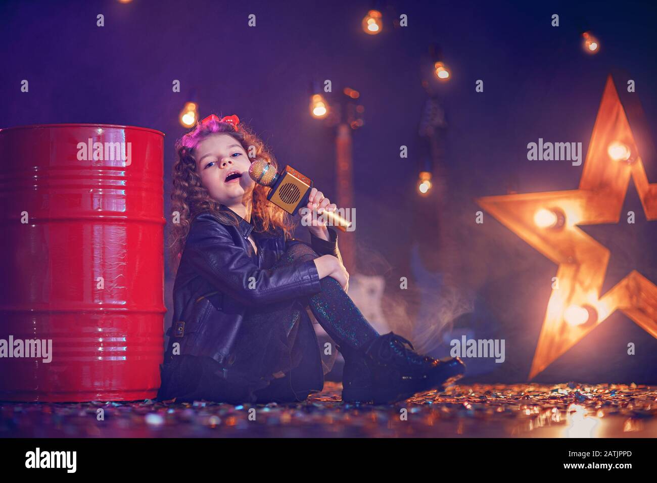 little beautiful girl with curly hair singing in recording studio Stock ...