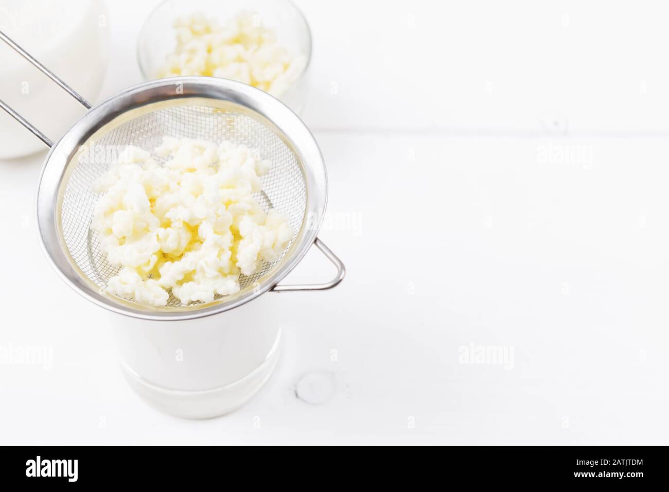 Homemade fermented beverage kefir with kefir grains in bowl on a white ...
