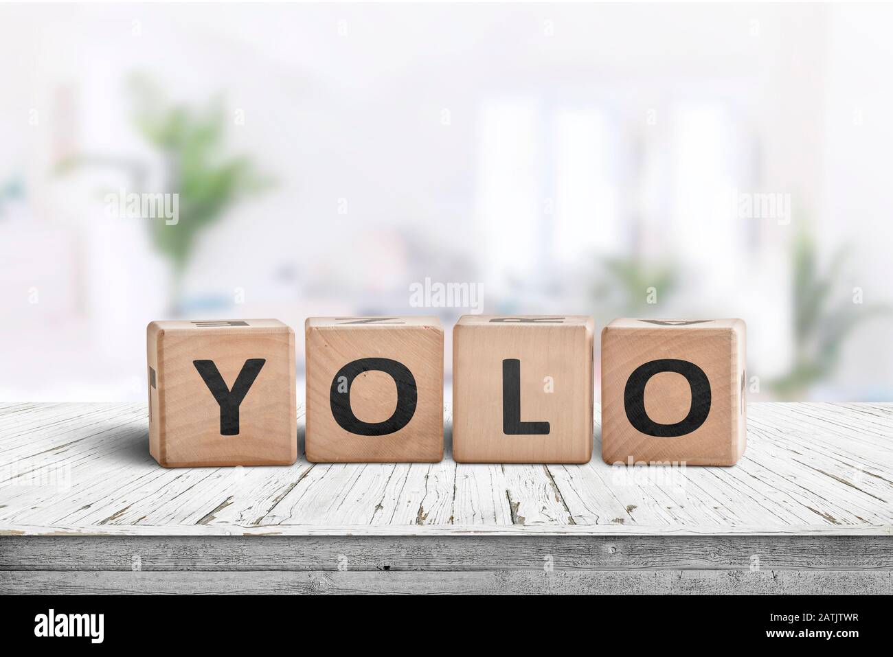 Yolo abbreviation sign in a bright living room on a white table Stock ...