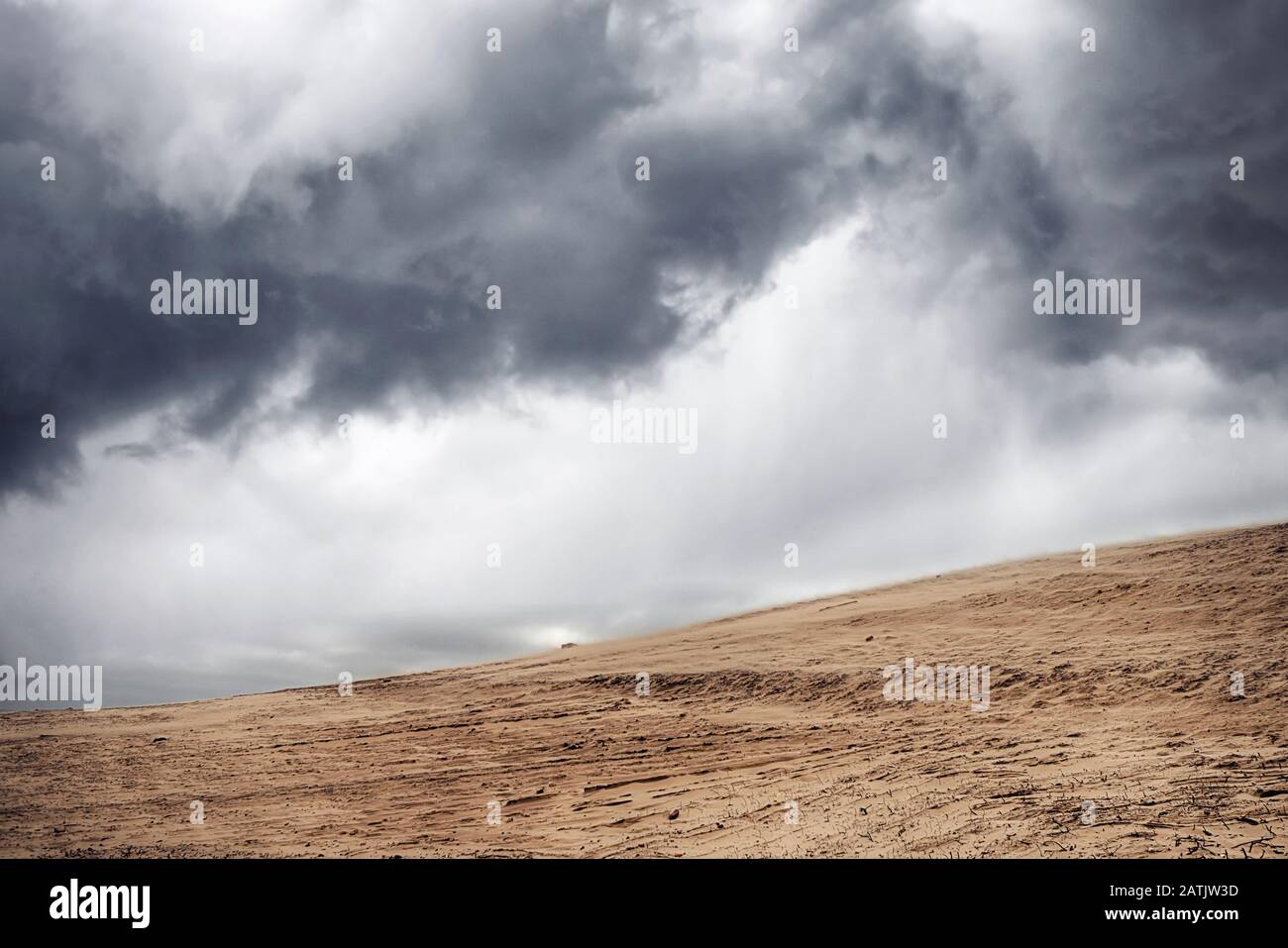 Sandstorm in a dry desert under a cloudy sky with dark clouds Stock ...