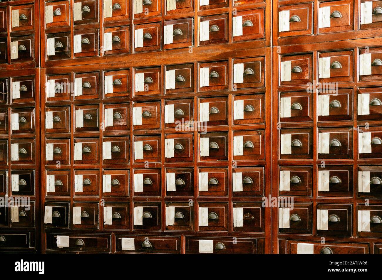 Wall with wooden drawers in traditional Chinese pharmacy preparing ...