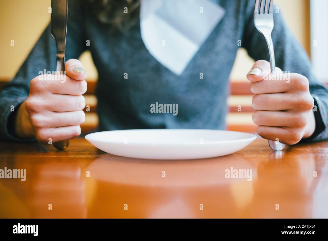 Woman sitting empty plate holding hi-res stock photography and images ...
