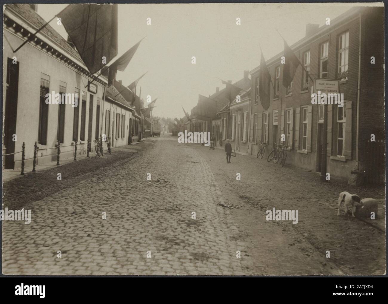 Description: Street in town with Belgian flags on the houses and a ...