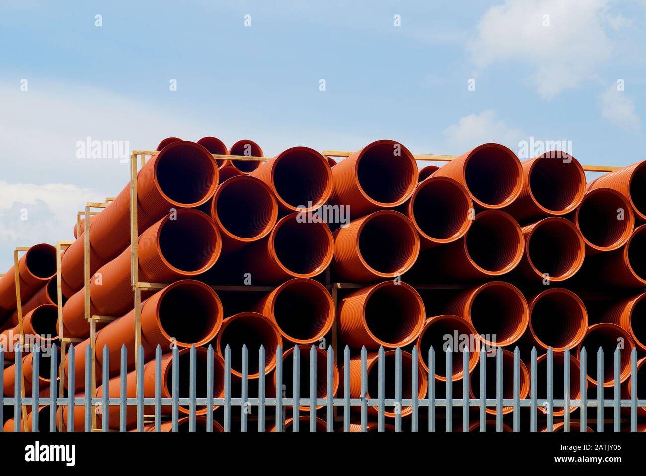Composition of building materials. Sewer pipes stacked on shelves Stock ...
