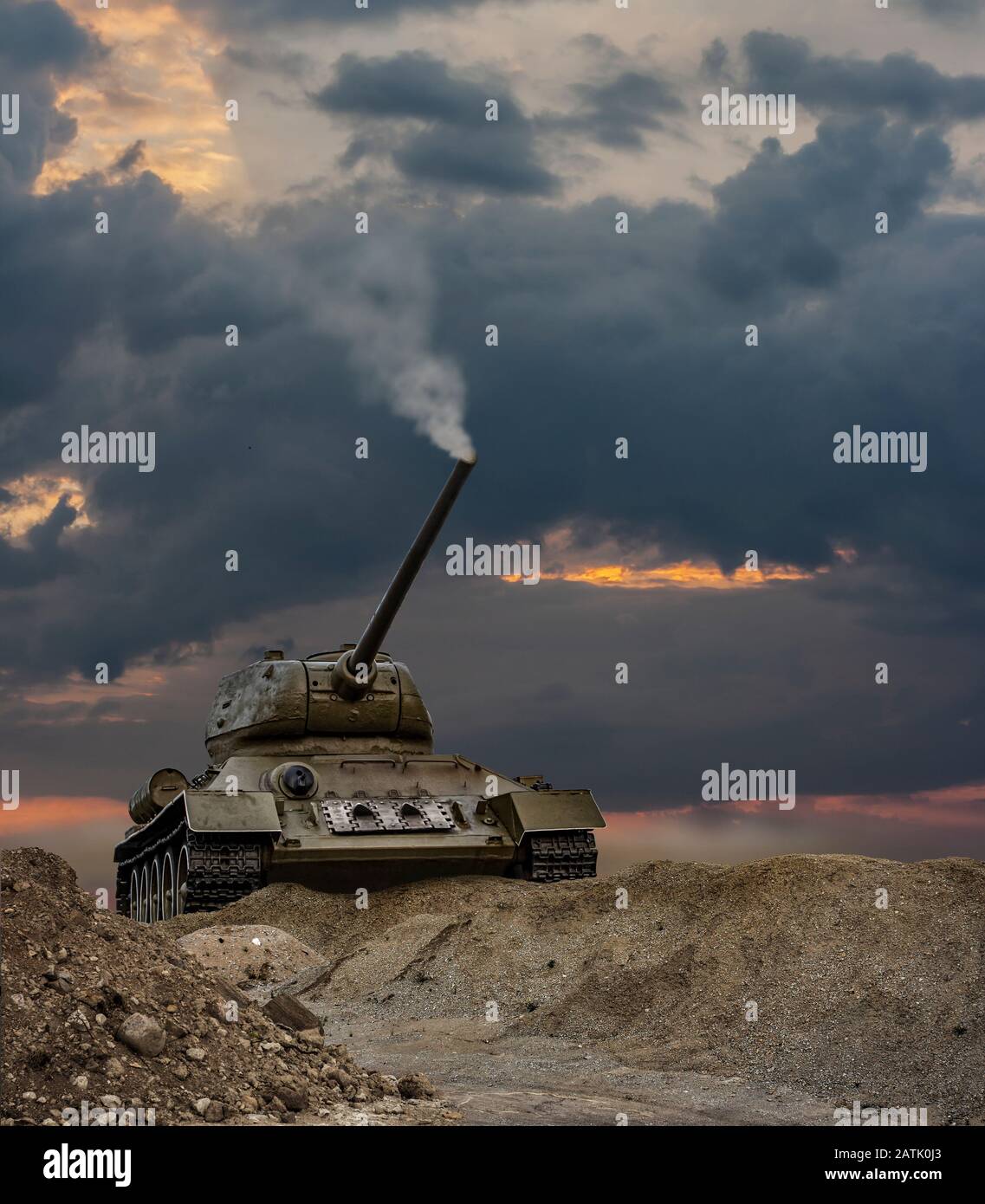 A tank with a smoking barrel approaching and aiming on a dramatic ...