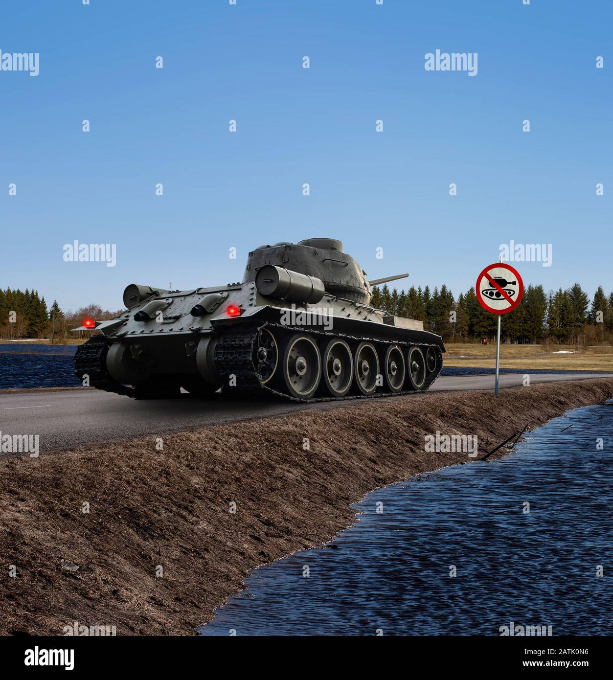 A funny peace image of a green tank having stopped on a coastal highway ...