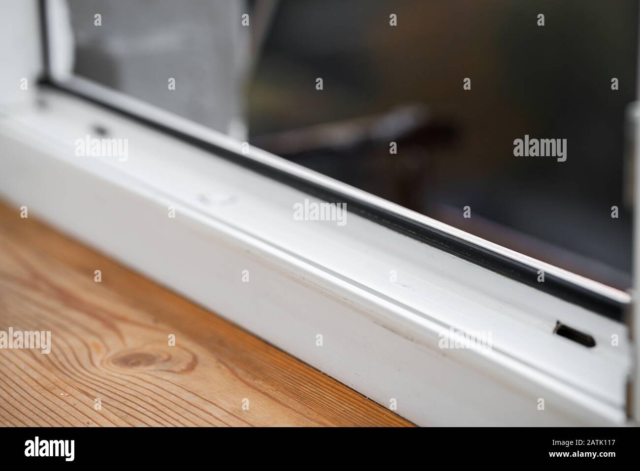 The master changes rubber seal gasket in pvc windows Stock Photo - Alamy