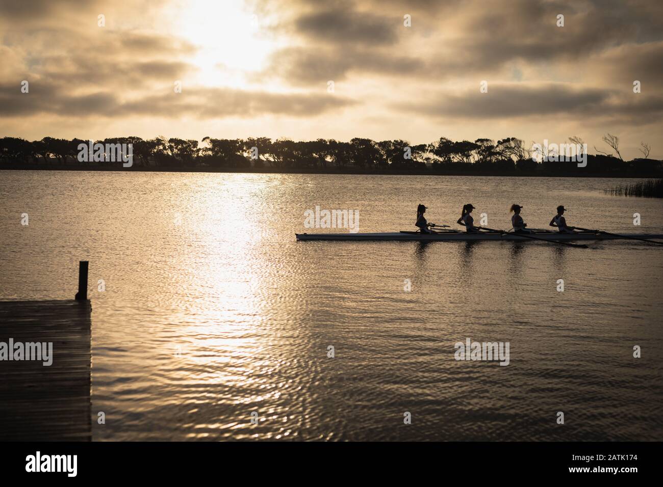 Female rowing team training on a river at the sunset Stock Photo - Alamy