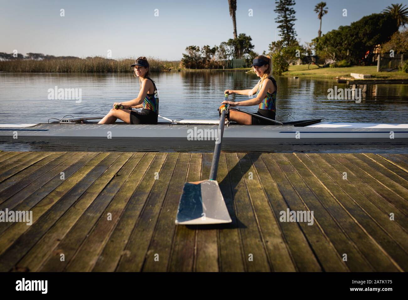 Female rowing team training on a river Stock Photo - Alamy