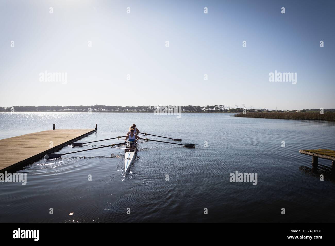 Female rowing team training on a river Stock Photo - Alamy