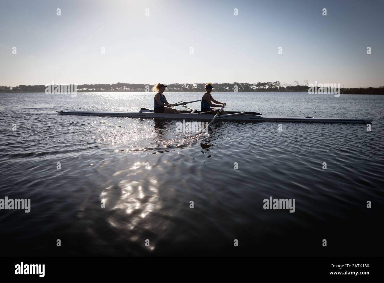 Female rowing team training on a river Stock Photo - Alamy