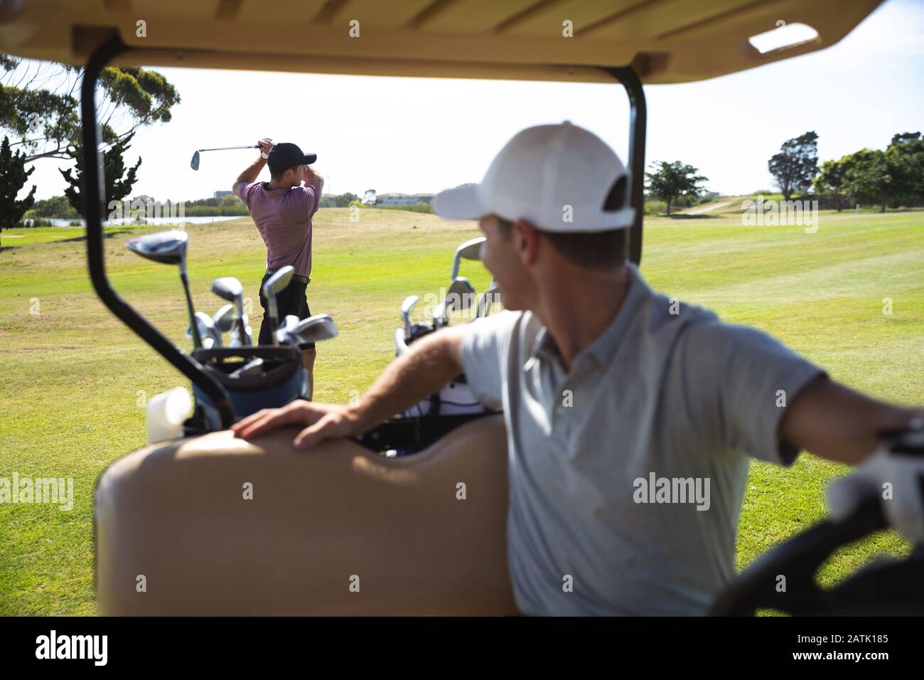 Golfer driving a golf buggy Stock Photo - Alamy