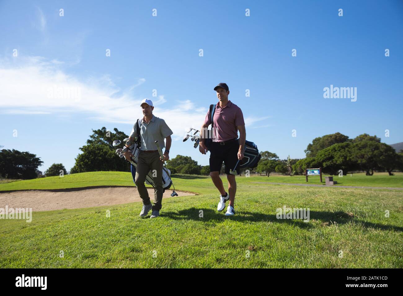 Golfers walking together with golf bag Stock Photo - Alamy