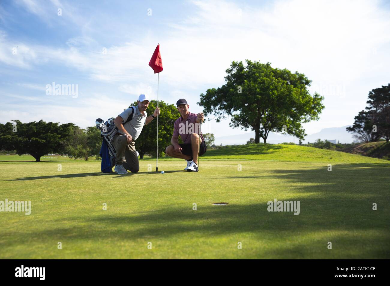 Golfers playing golf Stock Photo - Alamy