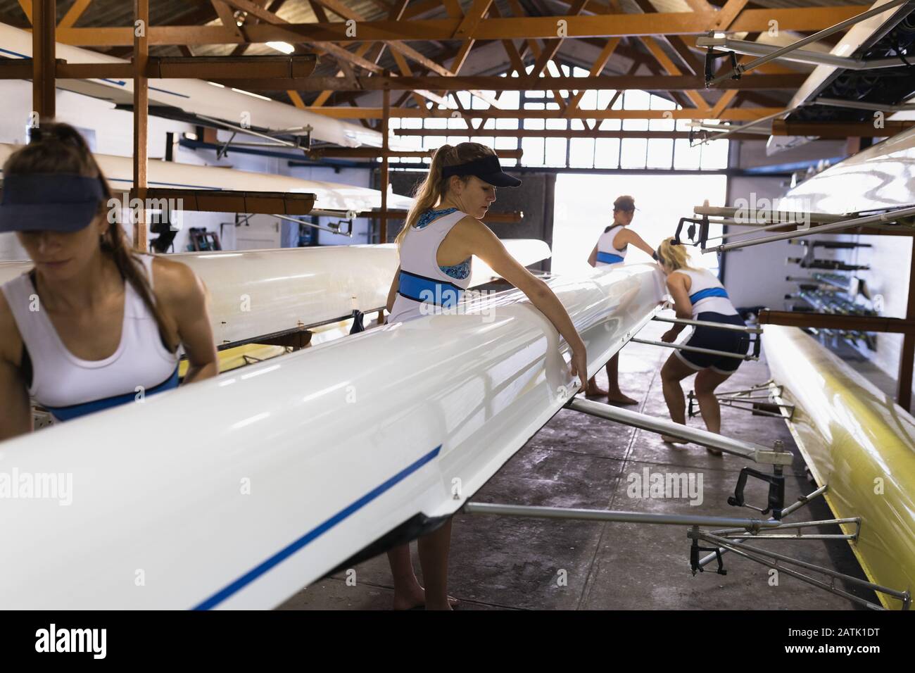 Female rowing team training on a river Stock Photo - Alamy