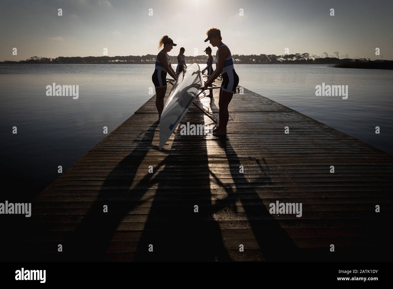 Female rowing team training on a river at the sunset Stock Photo - Alamy