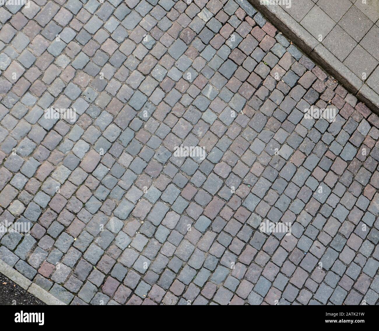 An old medieval cobblestone street texture photographed from above in ...