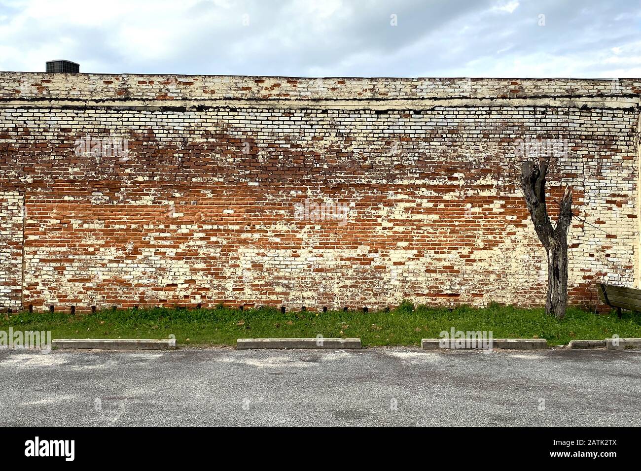 an old red brick building with an empty parking lot Stock Photo - Alamy