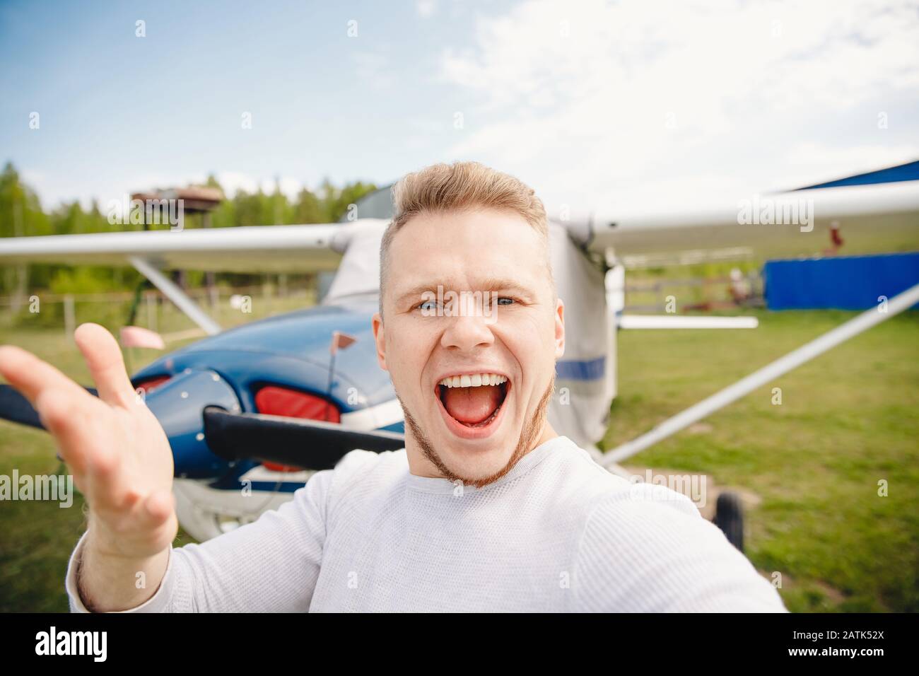 Pilot man taking selfie photo on background plane, smiling happily ...