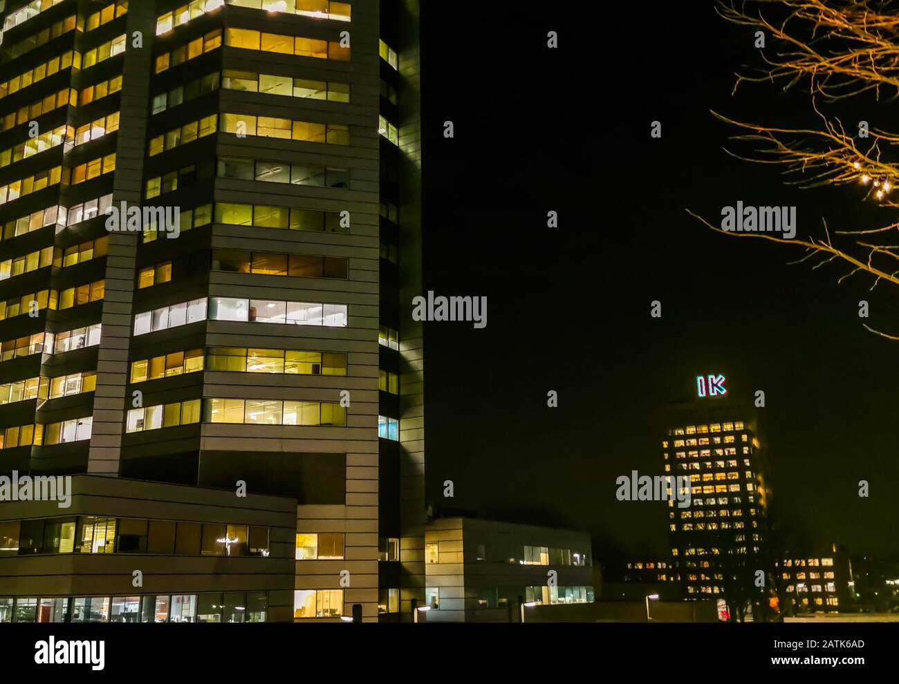 lighted sky scraper with other illuminated buildings by night, modern ...